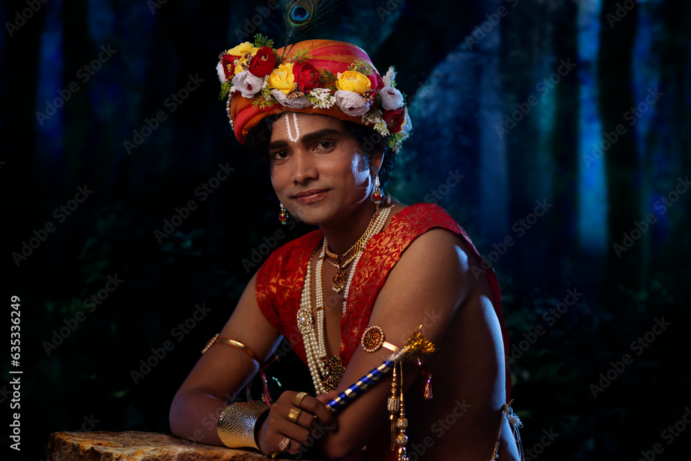 Young man dressed up as Lord Krishna on the occasion of Janmashtami ...