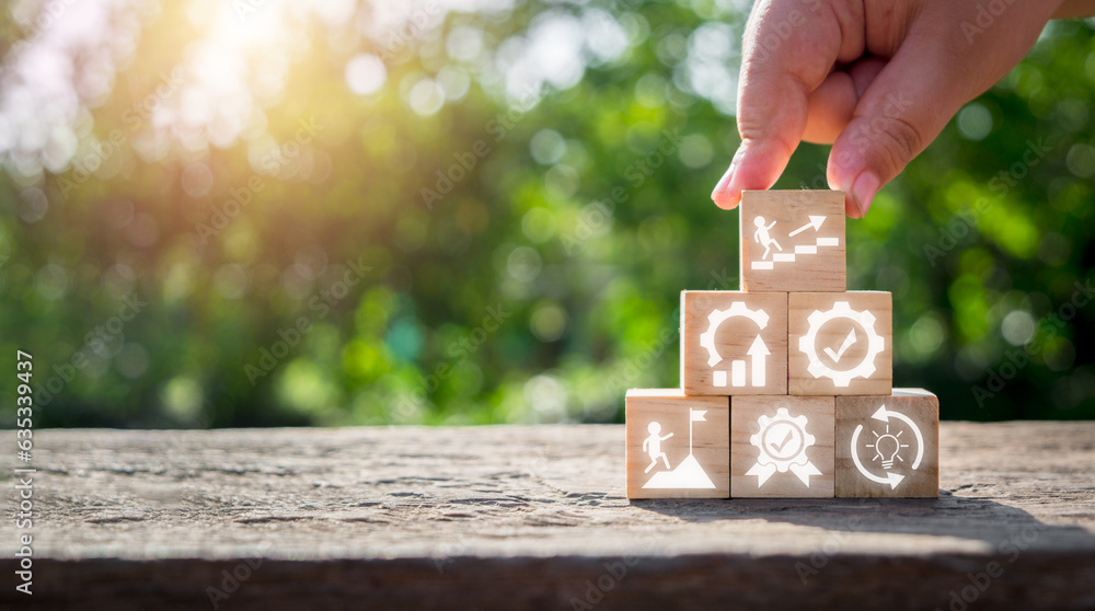 KAIZEN concept, Person hand holding wooden block with kaizen icon on ...