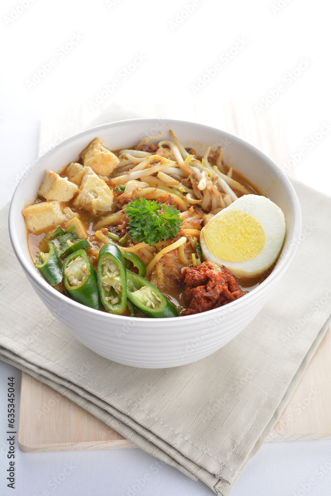 Malay mee rebus noodle with boiled egg, tofu, green chilli, sambal ...