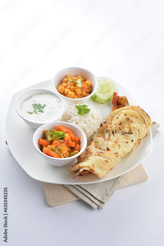 Indian traditional baked roti prata canai with curry vegetables, yogurt ...