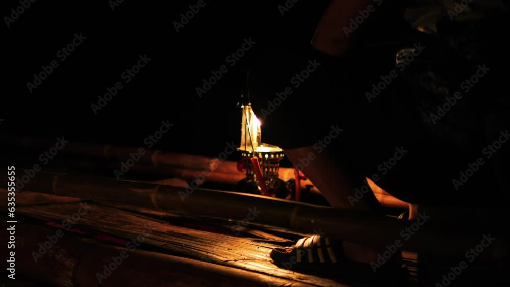 Bamboo raft with a burning lantern floats through natural limestone ...