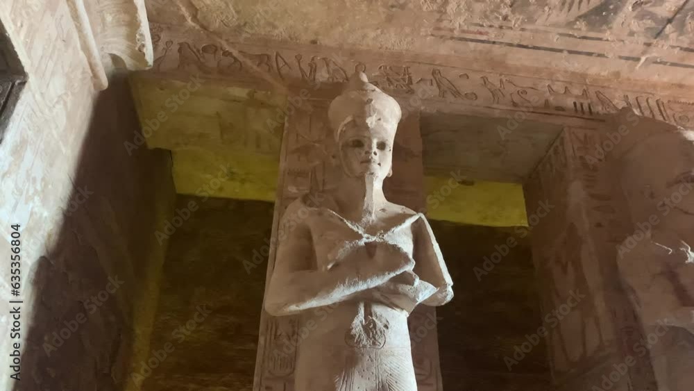 Statues Inside ancient Abu Simbel temple in Egypt. Daylight illuminates ...