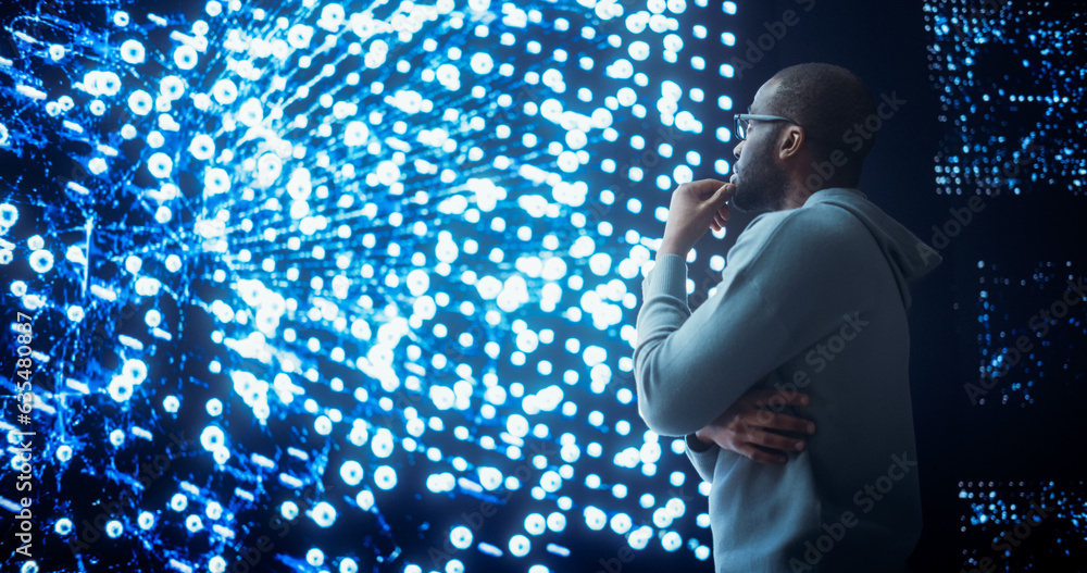 Black Young Man Looking at a Big Screen with Neural Network ...