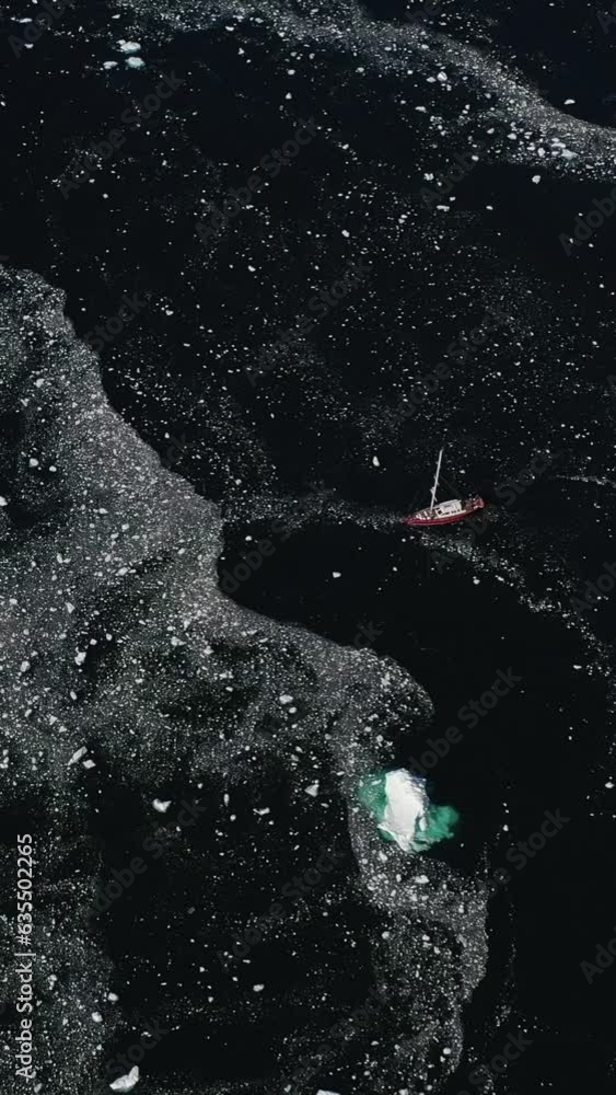 Vertical video, aerial view of ship in Antarctic Ocean of Antarctica ...