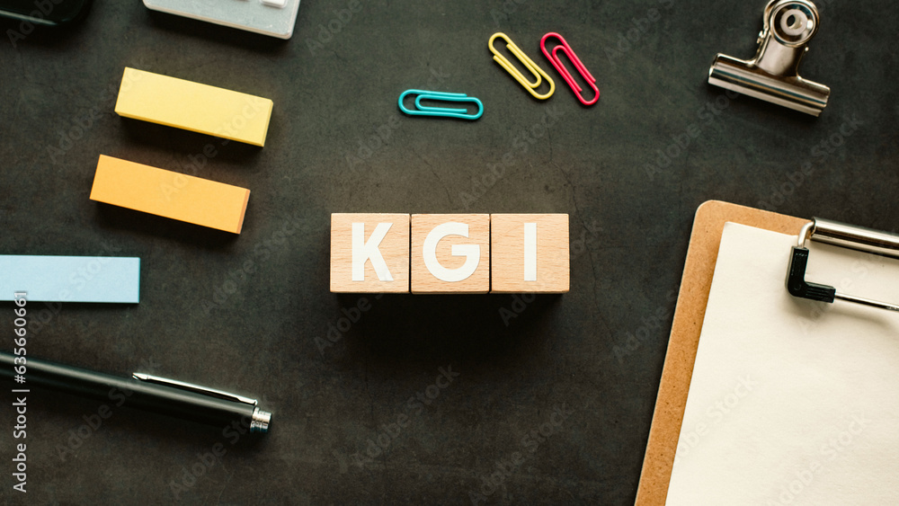 There is wood cube with the word KGI. It is an abbreviation for Key ...