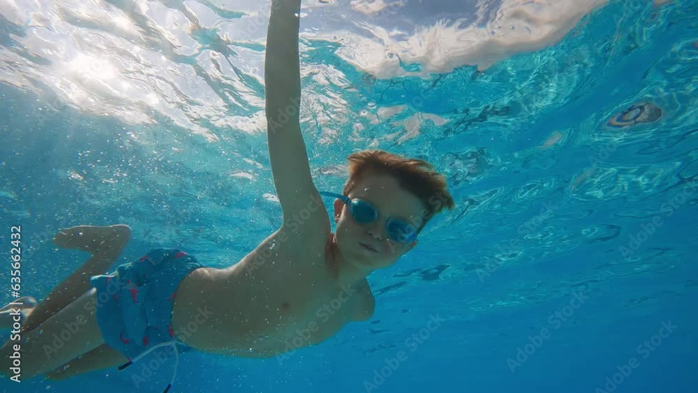 Cheeky 7 year old boy swims underwater with cheeks puffed, puts hand ...