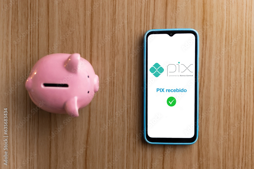 Smartphone displaying the PIX logo and a confirmation of payment ...