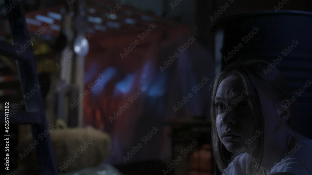 Scared blonde girl, victim of the horror maniac hiding from the man ...