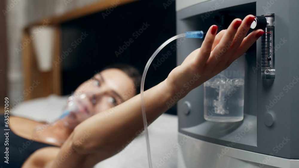 Portrait of a sick young woman who uses an oxygen concentrator and an ...