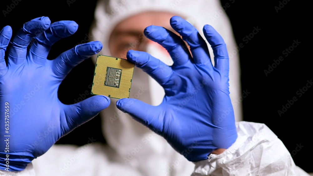 Engineer man in sterile suit is holding Microchip with symbols in ...