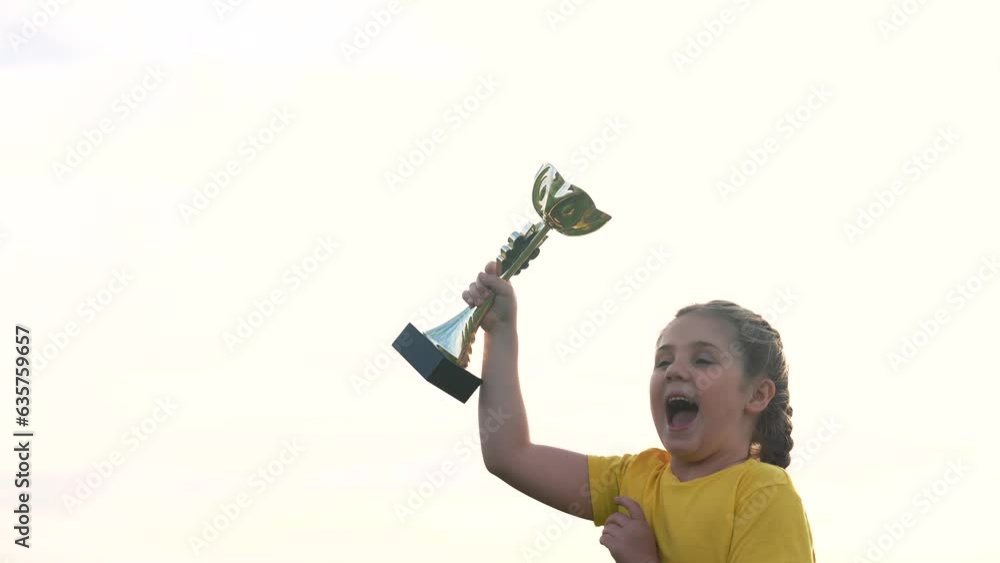 Winner child silhouette. Kid with cup of success raises her hand ...