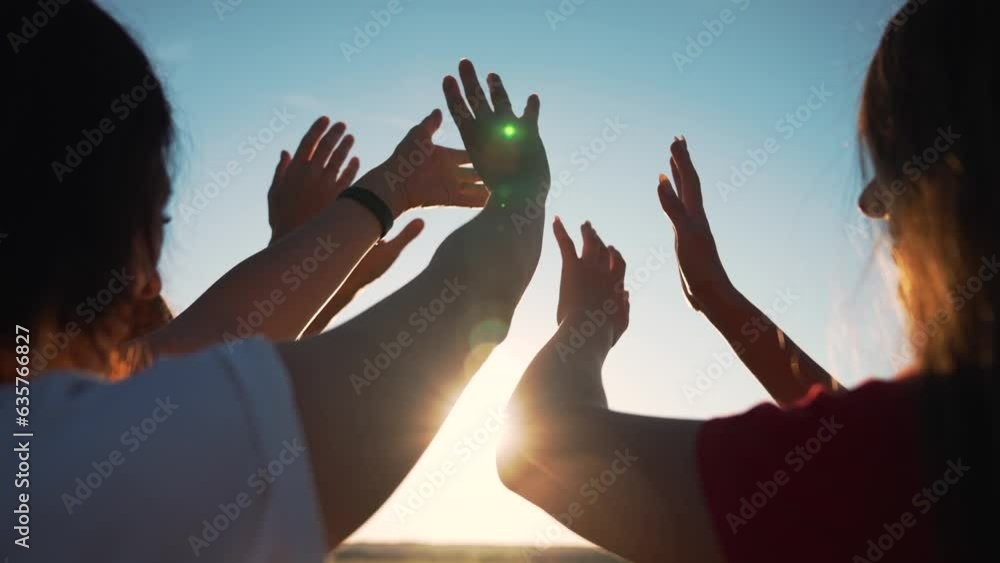 Group of people pulls their hands to sun sky. Teamwork religion and ...