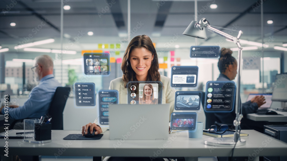 Young Businesswoman Using Laptop Computer in Office with Colleagues ...