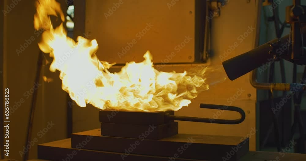 Hot fire is coming from the blow torch tool at the production facility ...