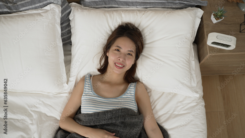 top view young and beautiful asian girl lying in comfort white bed ...