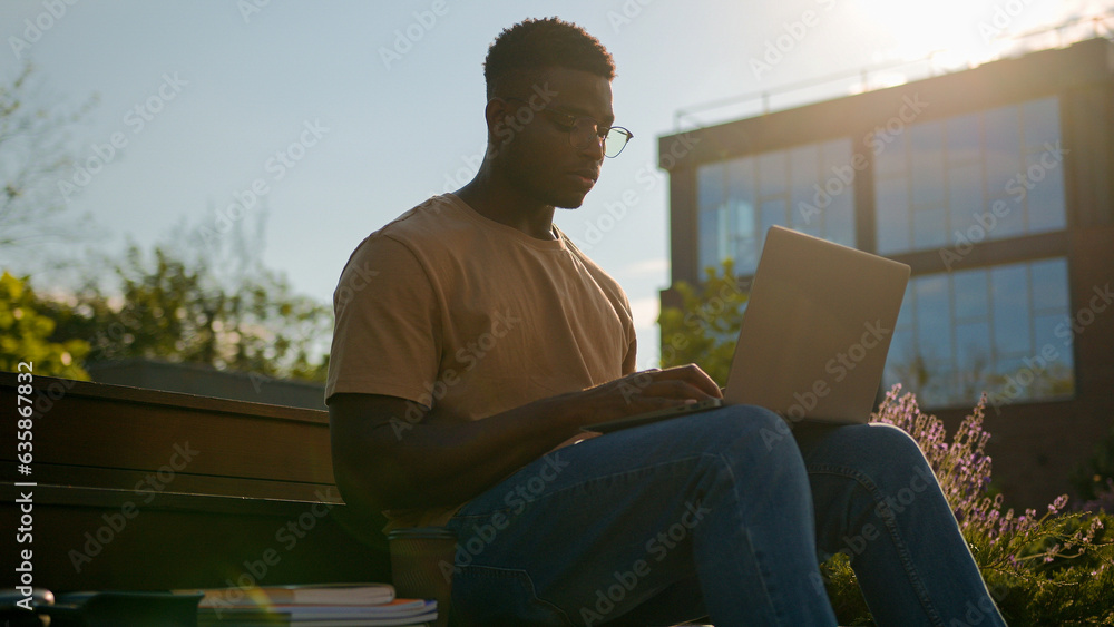 African American man student guy studying outdoors with computer male ...