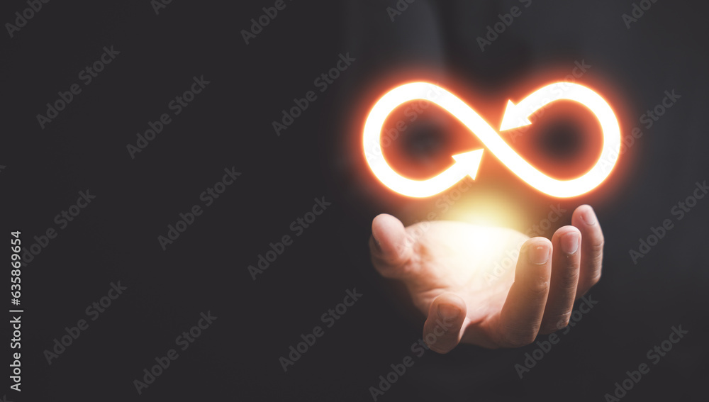 Businessman with circular infinity symbol on palm, symbolizing circular ...