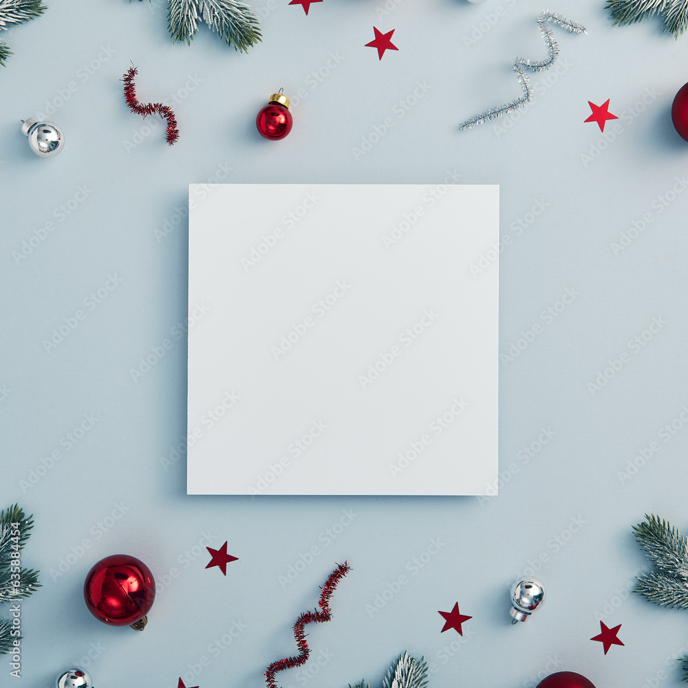 Winter-themed square flat lay with snowy branches and an empty white ...