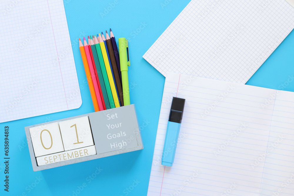 01 September. Image of a wooden calendar for September 1 on a blue ...