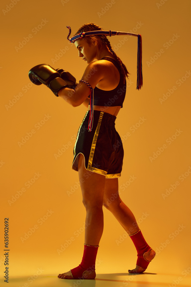 Teen girl, MMA fighter in uniform and boxing gloves, standing in ...