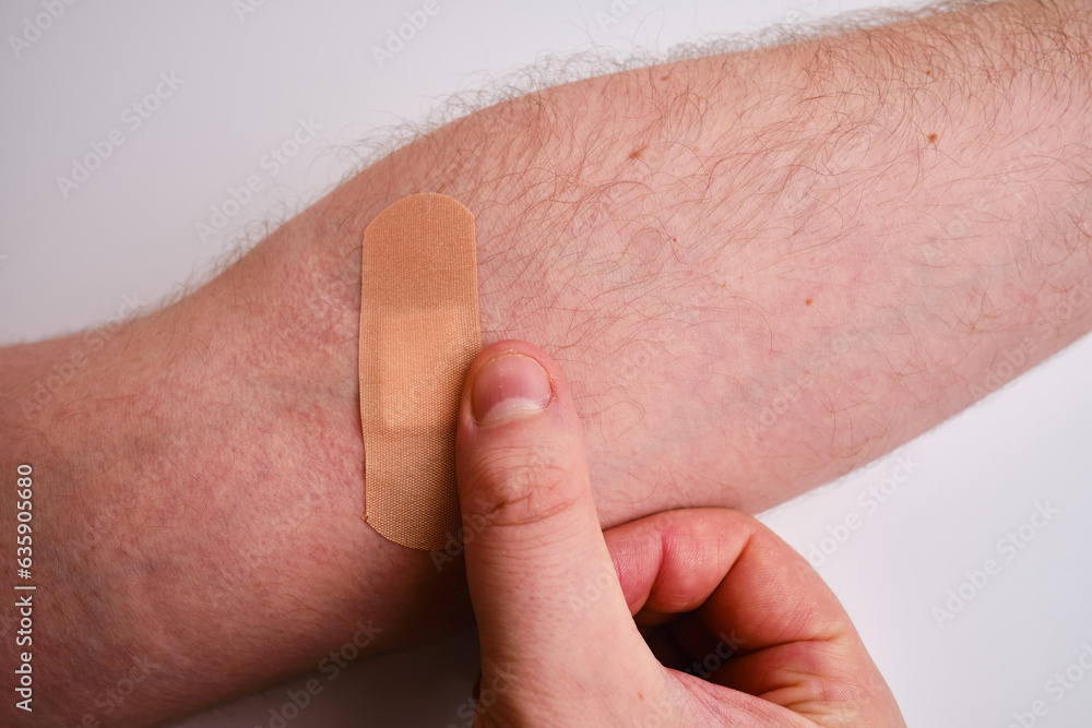 Foto de Male hand with a medical adhesive plaster close-up. Adhesive ...
