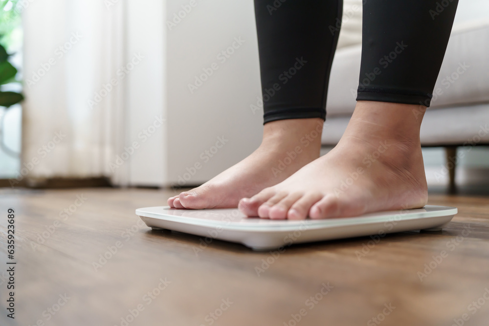 Fat diet and scale feet standing on electronic scales for weight ...