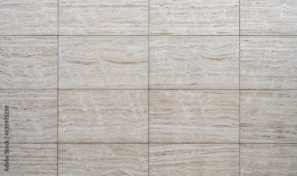 texture of a tiled beige stone wall as background, natural stone wall ...