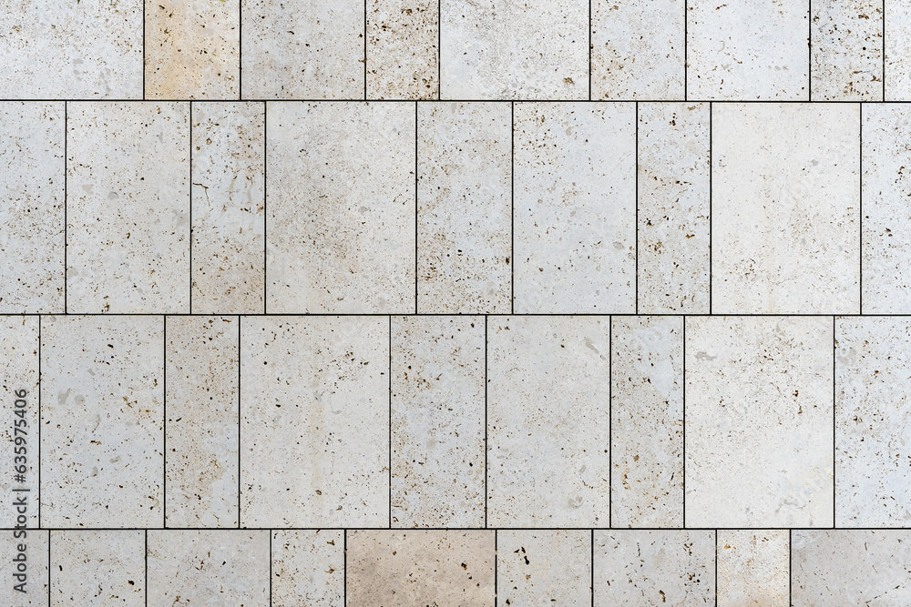 texture of a tiled beige stone wall as background, natural stone wall ...