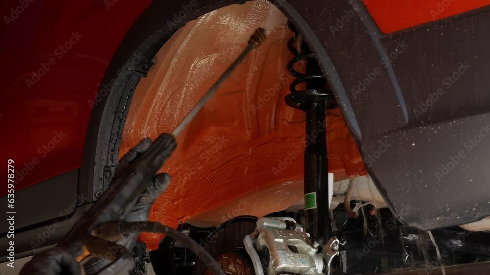 Washing the rear arches of the car in the service, under high pressure ...