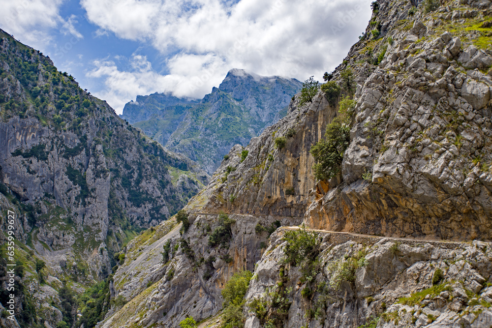 the narrow hiking trail winding along the rock face in the ruta del ...