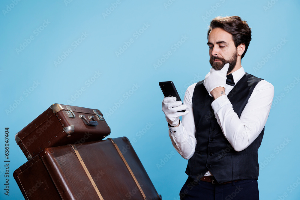 While behaving as skilled member of elegant hotel staff on camera ...