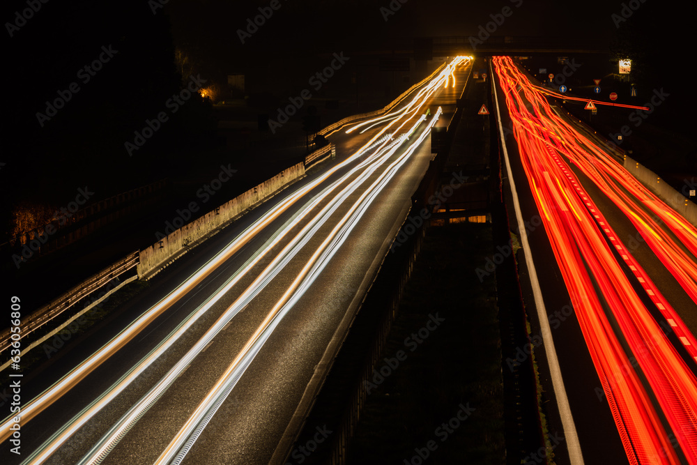 Abstract image of night traffic lights on the road. Car light trails at ...
