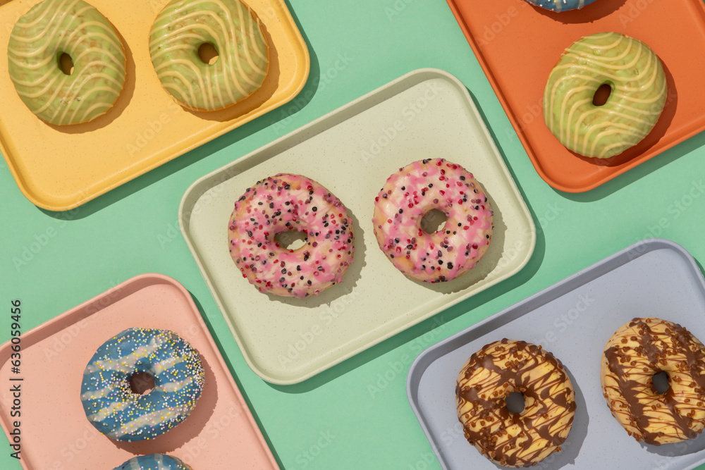 Pastel color donuts with colorful trays on mint green background Stock ...