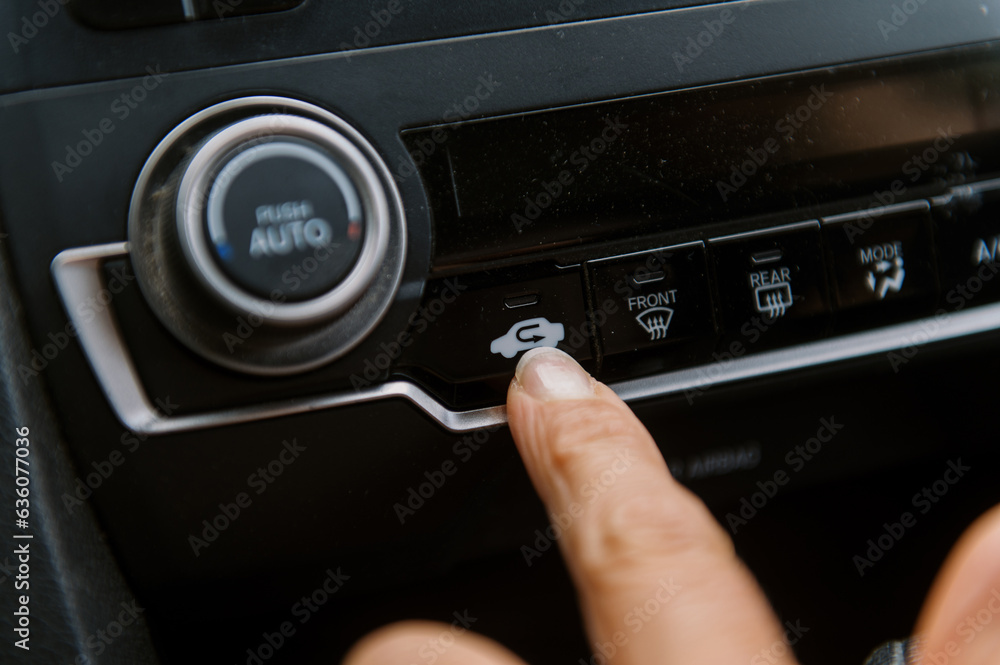 middle aged woman inside a car pushing button Stock Photo | Adobe Stock