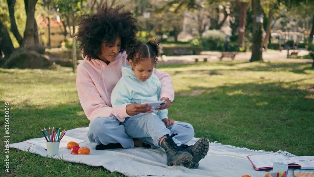 Mother Daughter Looking Smartphone At Picnic Park Mom Showing Cartoon