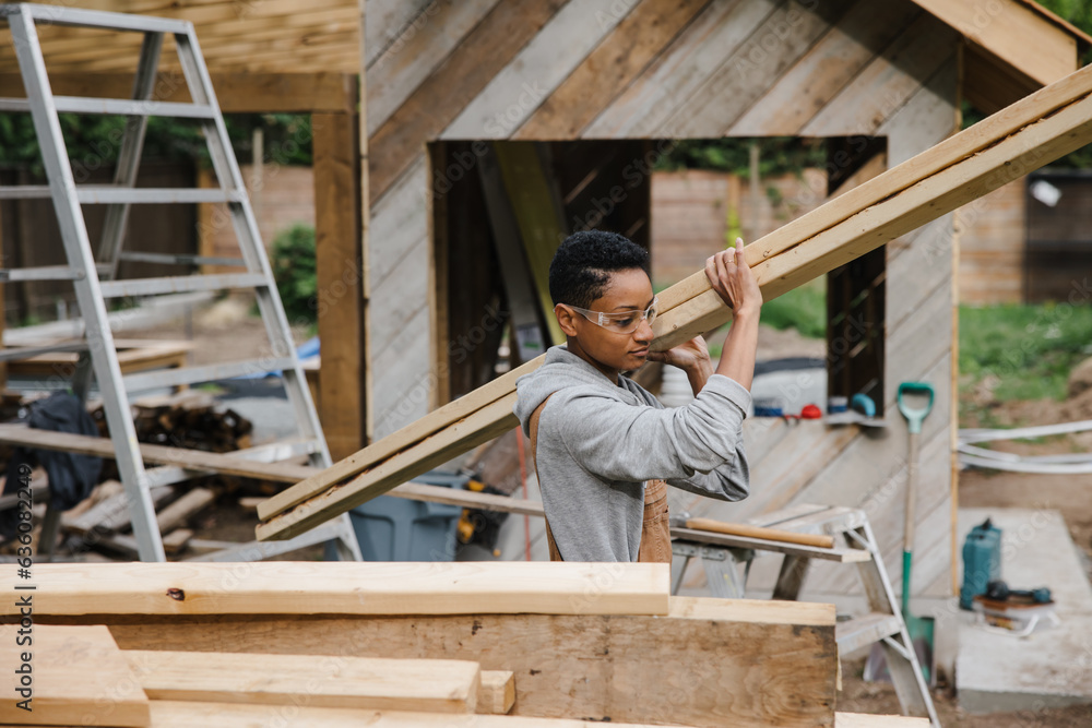 Carpenter stacking wood pile of 2X4 lumber. Stock Photo | Adobe Stock