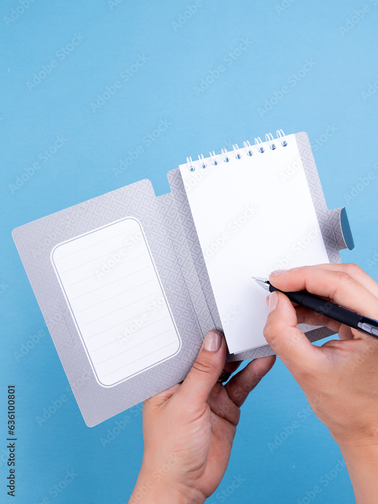 Design concept - top view of a woman writing in a notebook with white ...