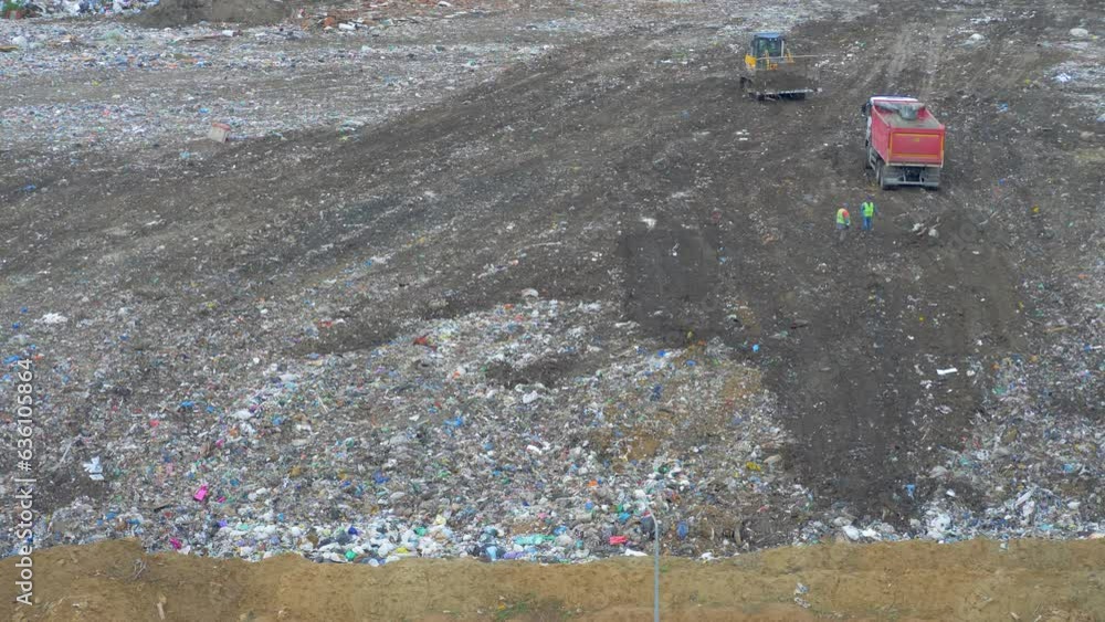 Tractor compactor and garbage truck on trash dump landfill site with ...