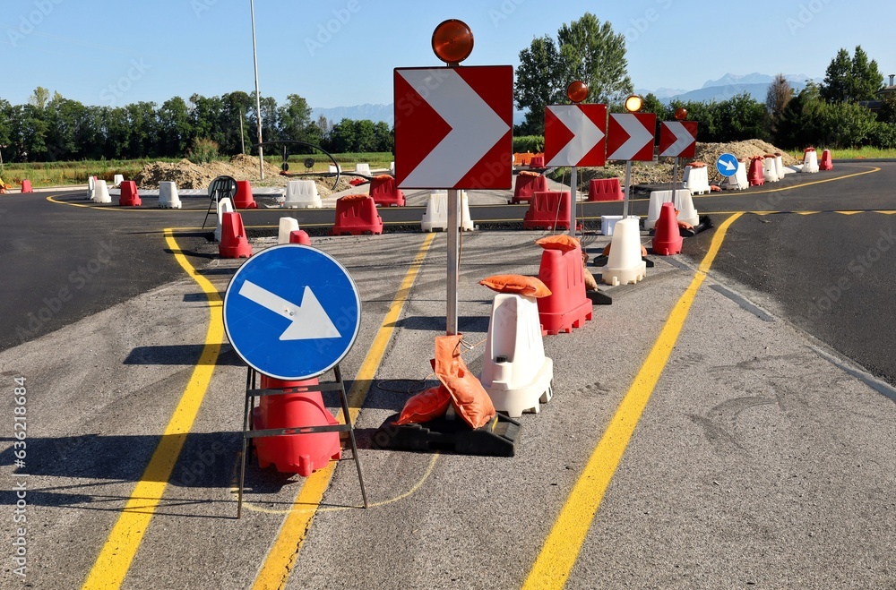 Circle and square directional road signs with warning lights and red ...