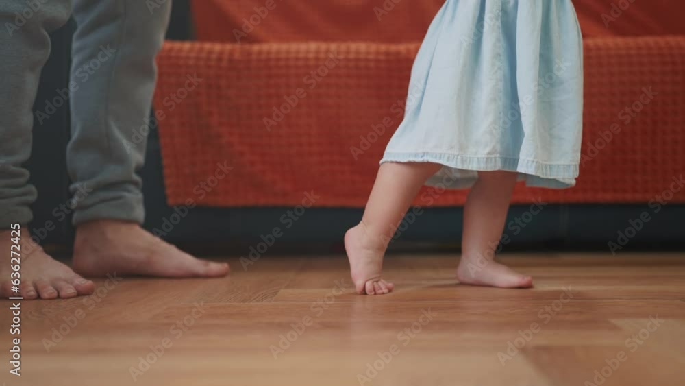 baby first steps. daddy a teaches baby toddler daughter to take first ...