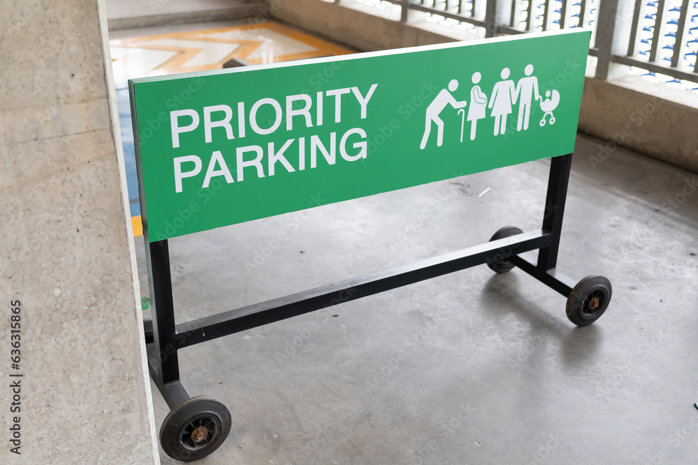 Green sign with Priority parking for vehicles of people with ...