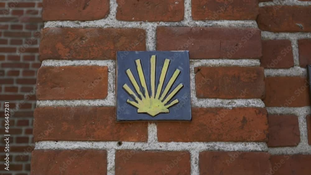 Rising sun sign. Ceramic tiles on the wall of a red brick church ...