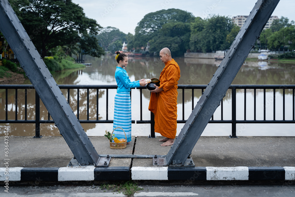Women make merit offer food and put it in monk alms bowls with monks in rural areas according to ...