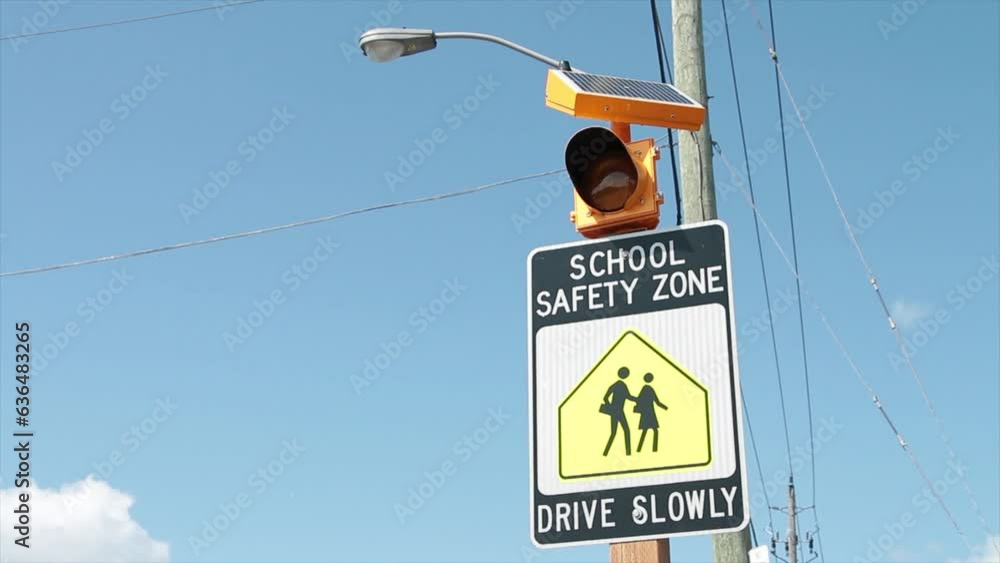 school safety zone drive slowly sign with illustration of people ...