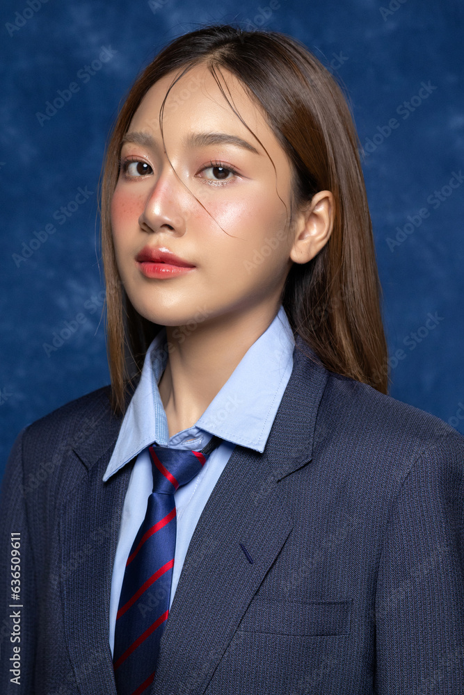 Beautiful Asian woman in school uniform taking a photo of yearbook ...