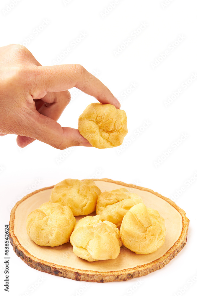Hand Holding Cream puffs (Choux cream or Eclair) isolated on white ...