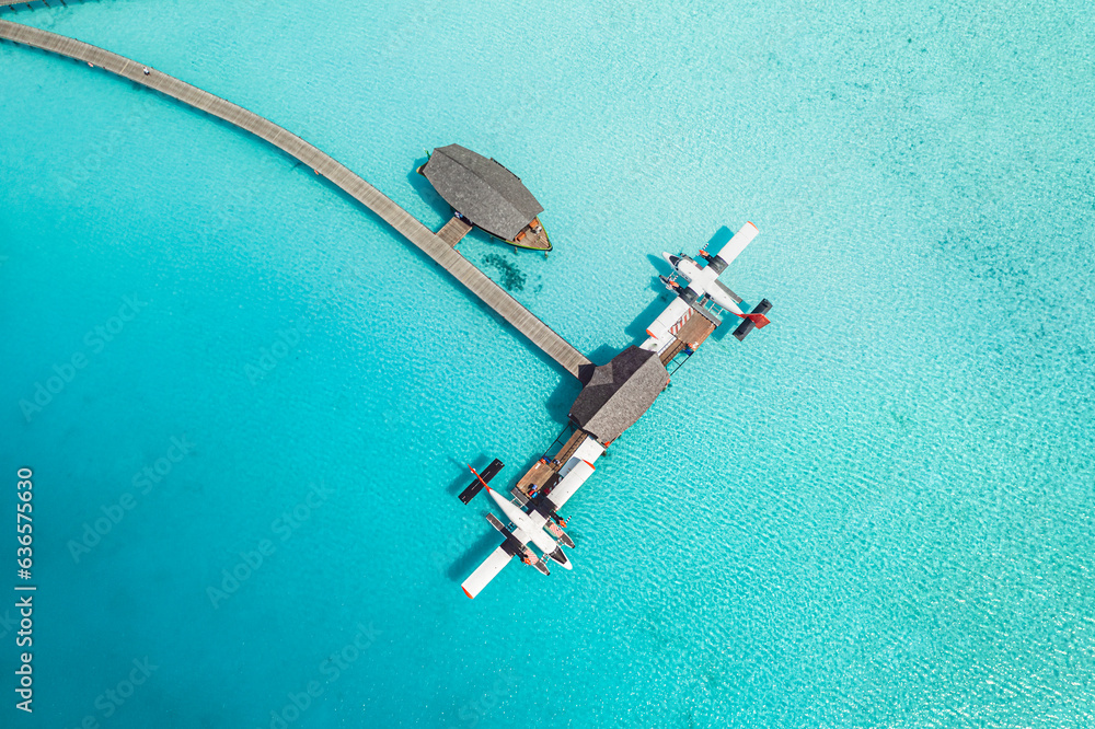 Beautiful aerial view of Maldives coast, pier water villa seaplane top ...
