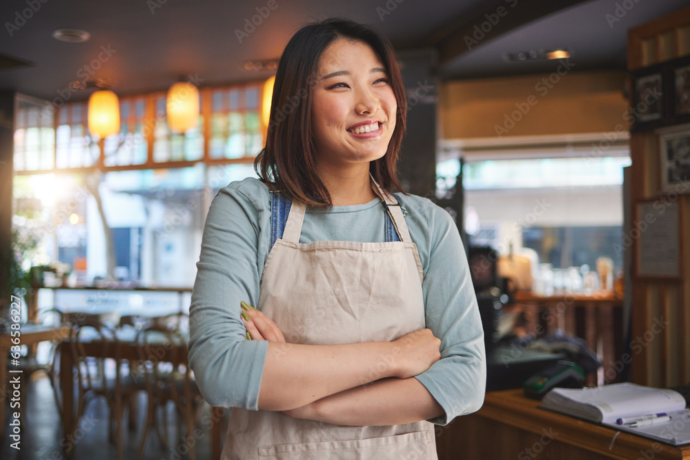 Smile, thinking and arms crossed with an asian woman in a restaurant ...