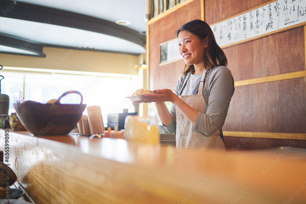 Chinese food, waitress and an asian woman in a sushi restaurant to ...