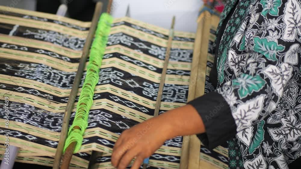 An Indonesian woman weaving traditional flores fabric. Traditional ...
